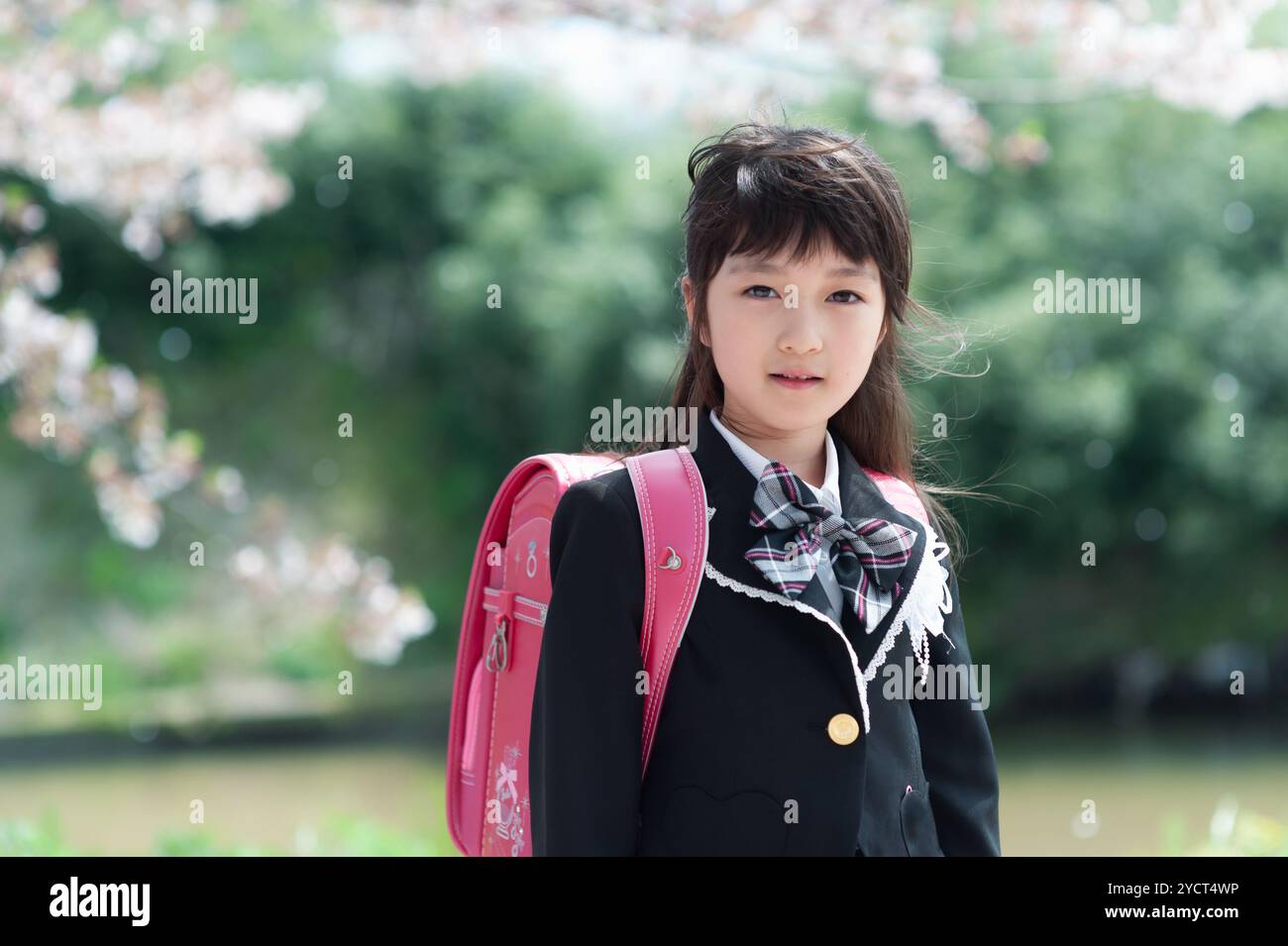 New first year girl smiling in formal dress Stock Photo - Alamy