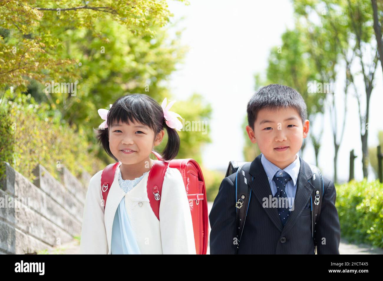 New first-year student in formal dress laughing in a residential area ...