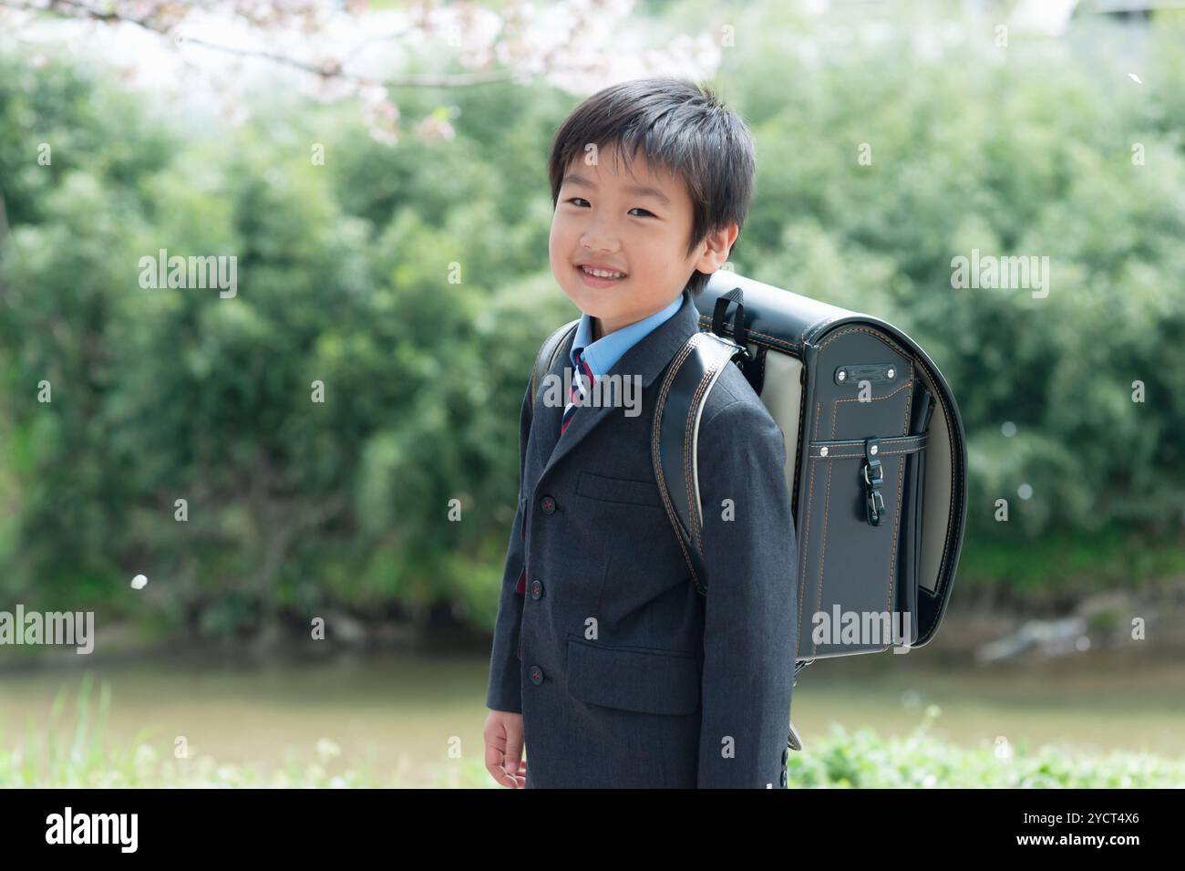 New first-year boy smiling in formal dress Stock Photo - Alamy