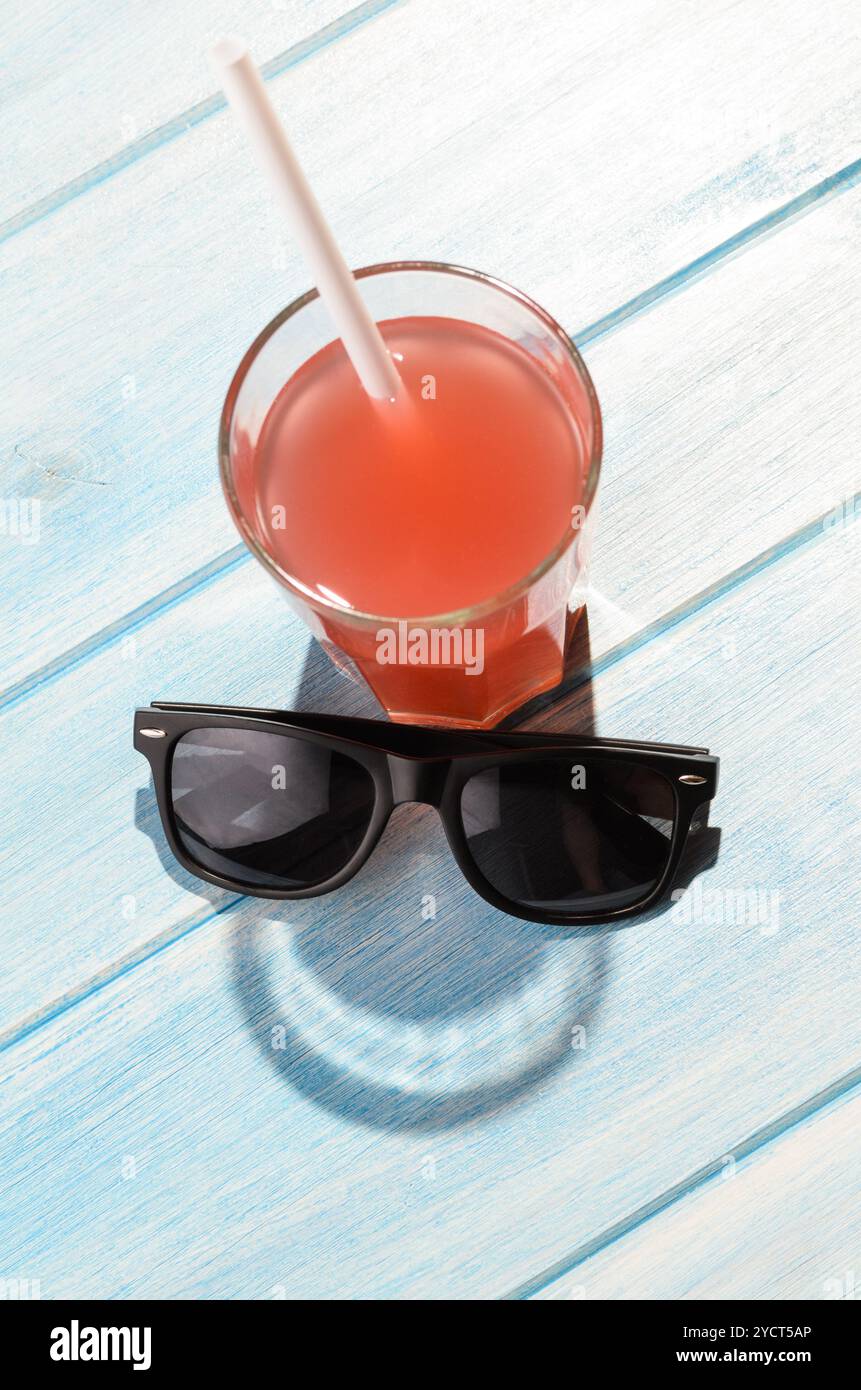 Smiley drink on beach table Stock Photo - Alamy