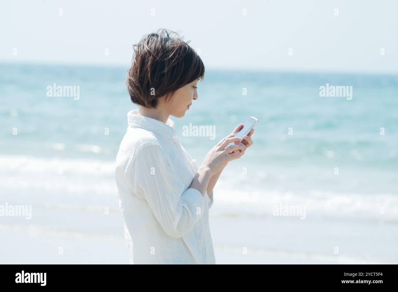 Woman staring at her phone screen Stock Photo - Alamy