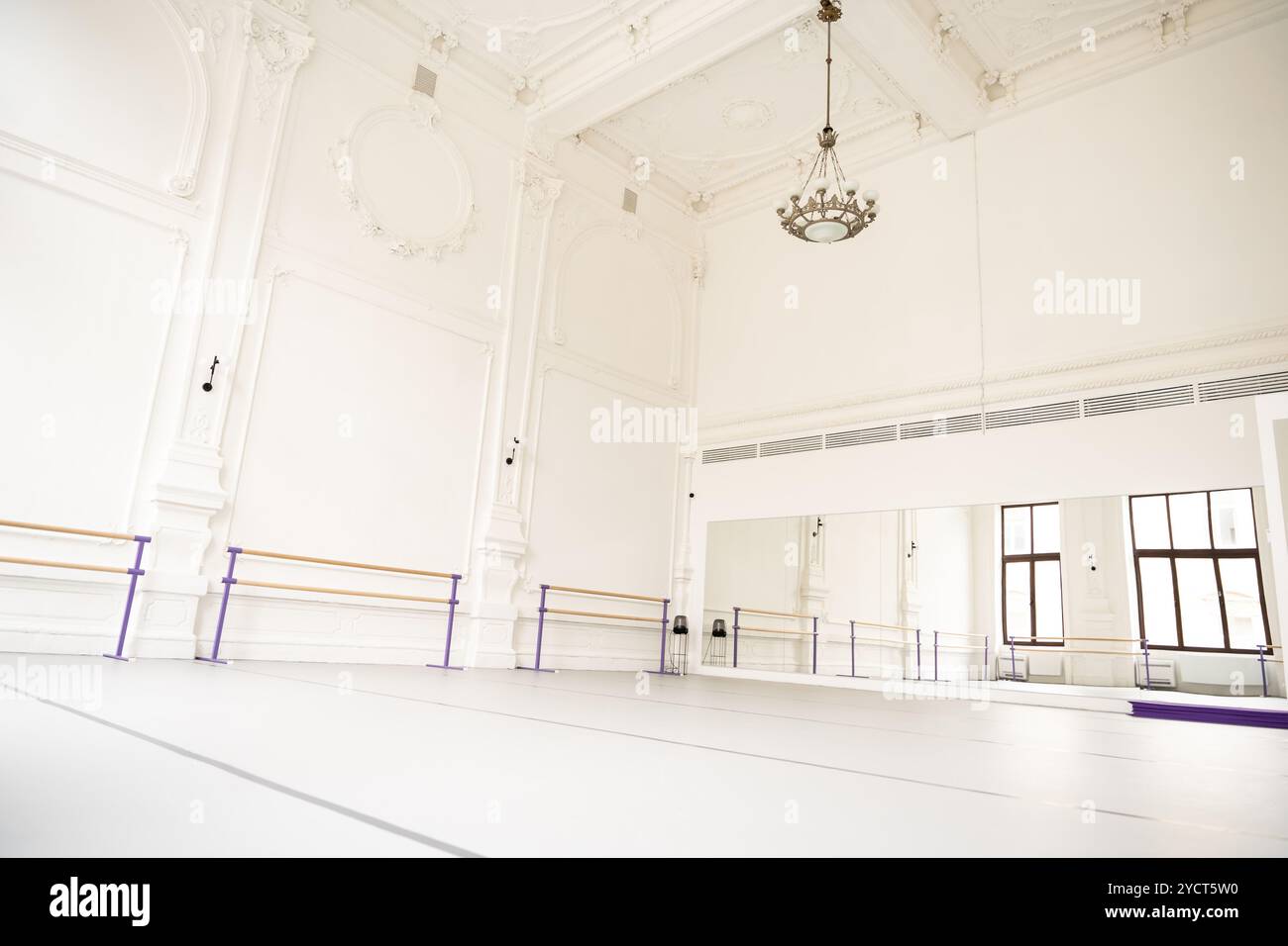 Empty room with barre on wall providing perfect space for stretching ...