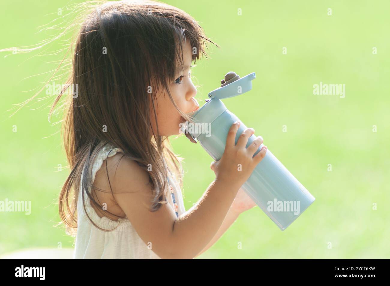 Girl drinking from water bottle Stock Photo - Alamy