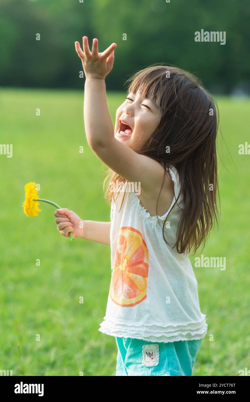 Girl smiling happily after receiving flowers Stock Photo - Alamy