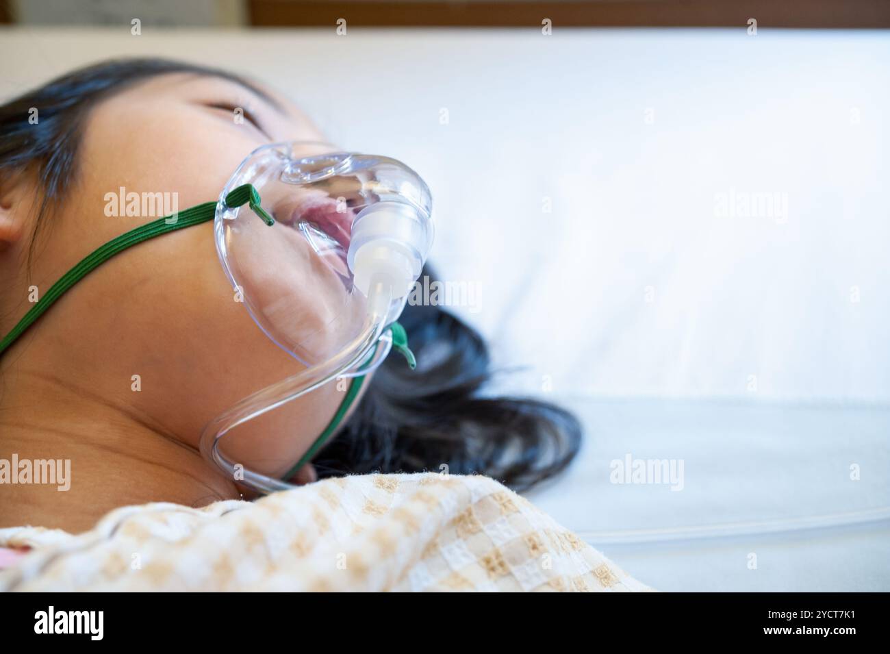 Girl sleeping with oxygen inhaler Stock Photo - Alamy