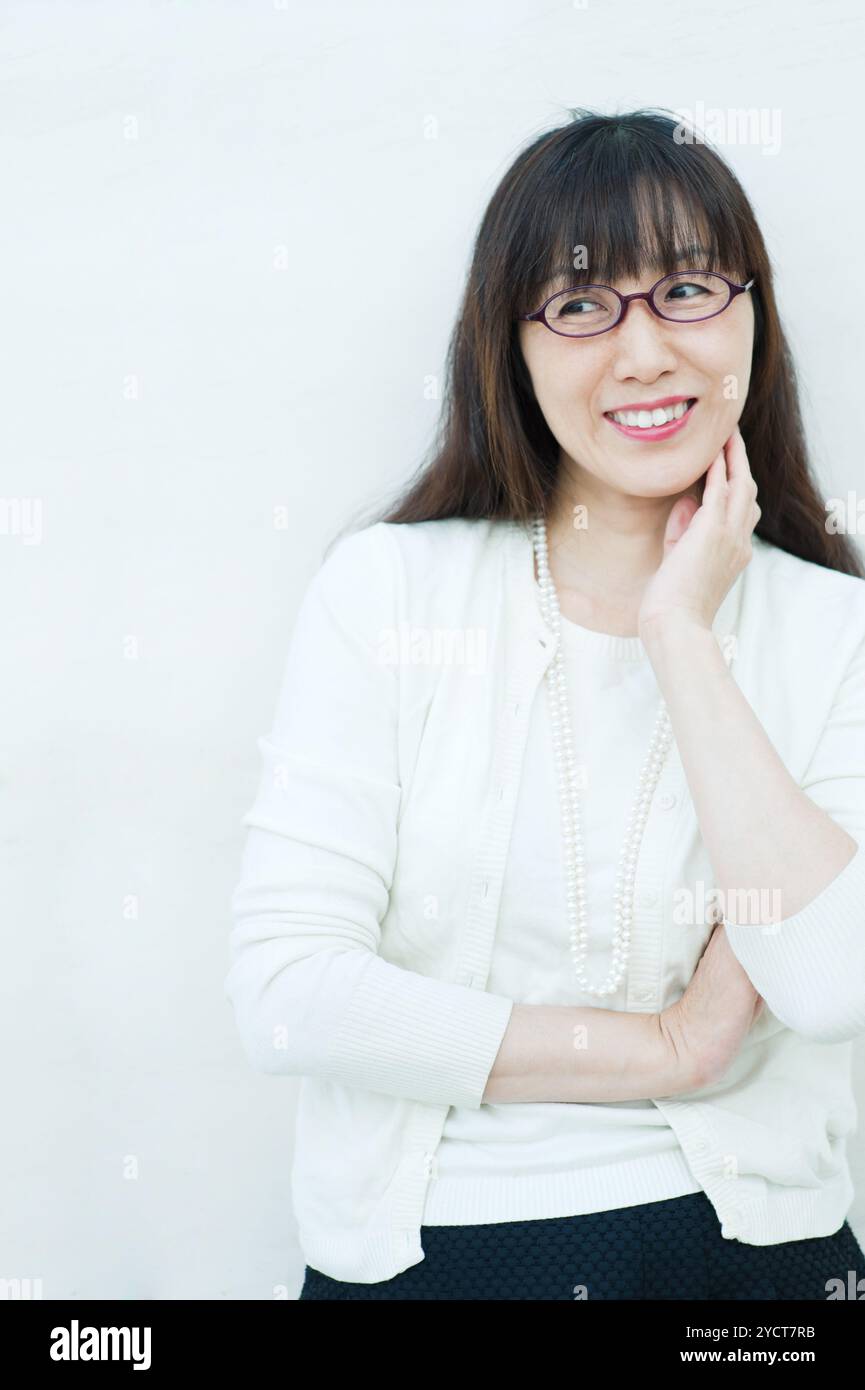 Thinking woman with hand on cheek Stock Photo - Alamy