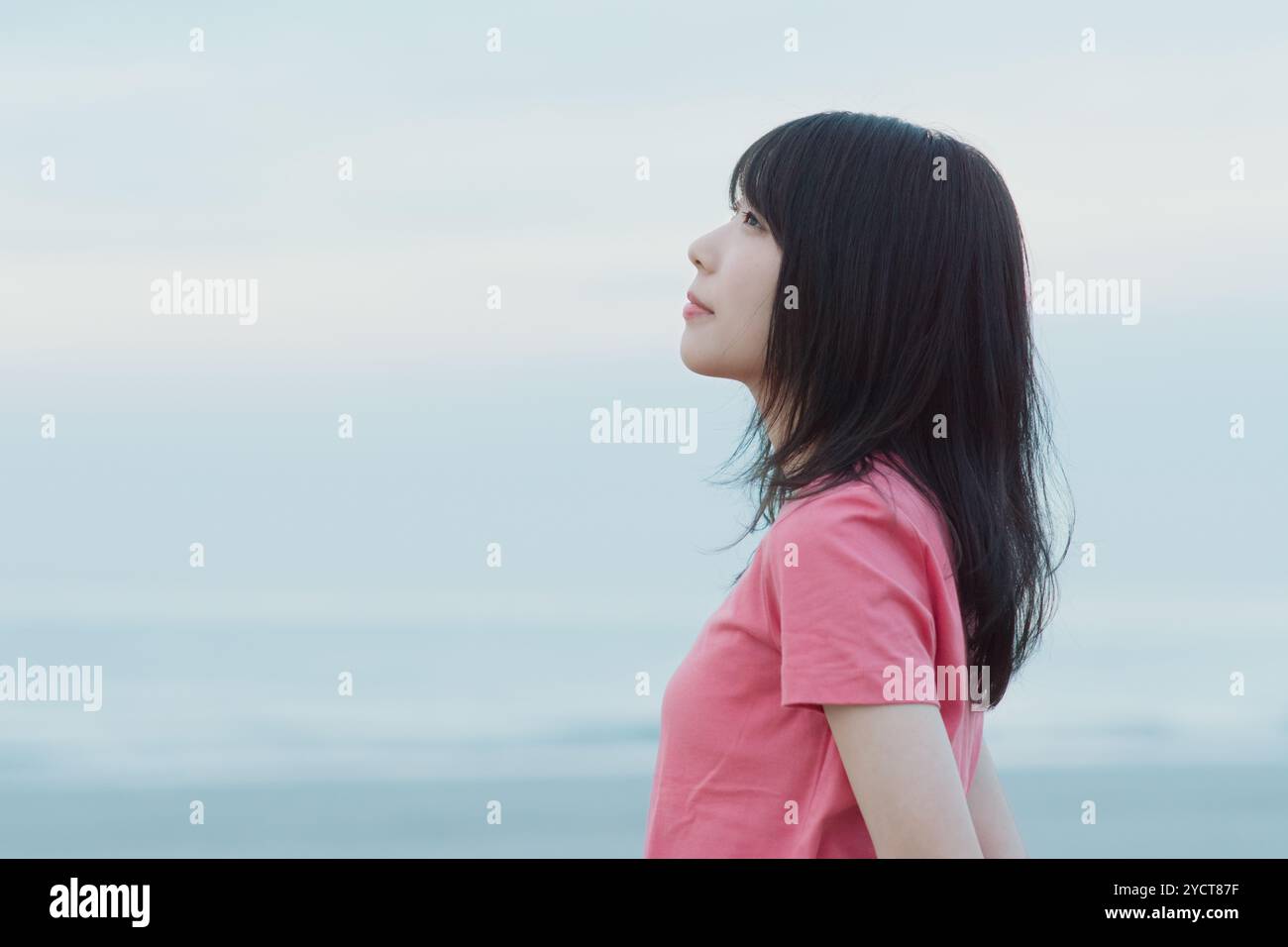 Woman looking up in profile Stock Photo - Alamy
