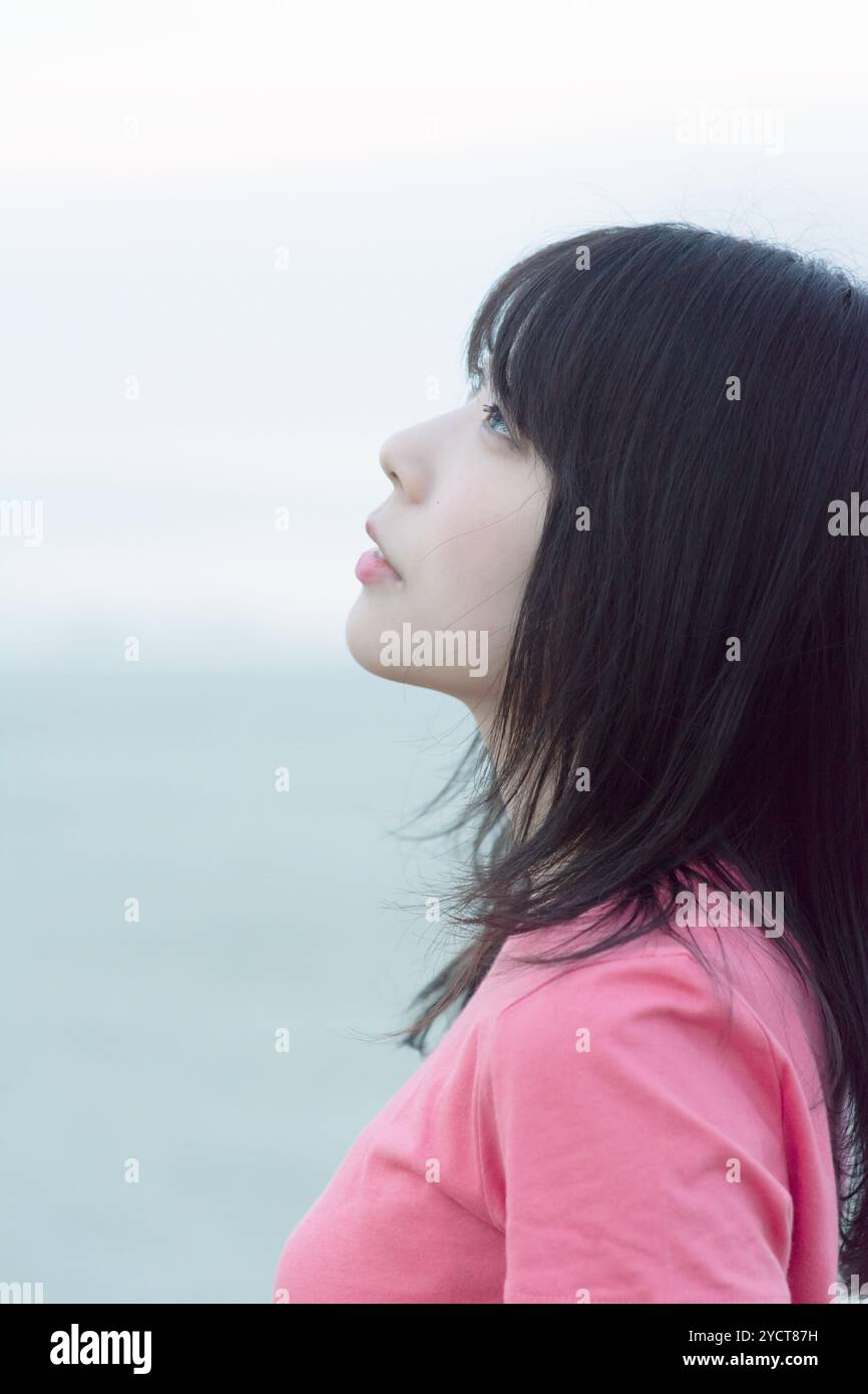 Woman looking up in profile Stock Photo - Alamy