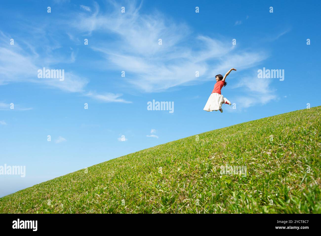 Woman jumping in grass field Stock Photo - Alamy