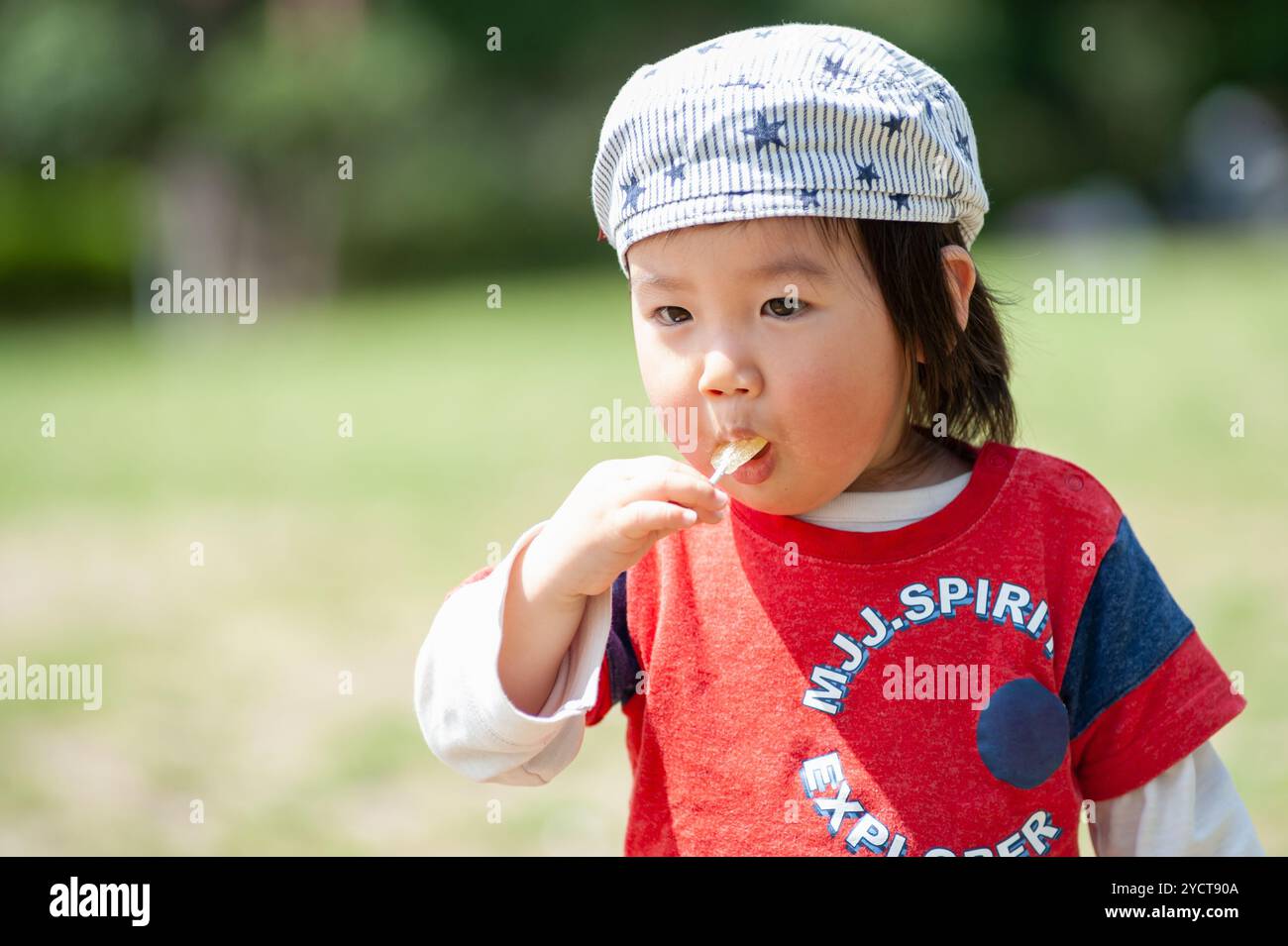 Toddler with candy in cheek Stock Photo - Alamy