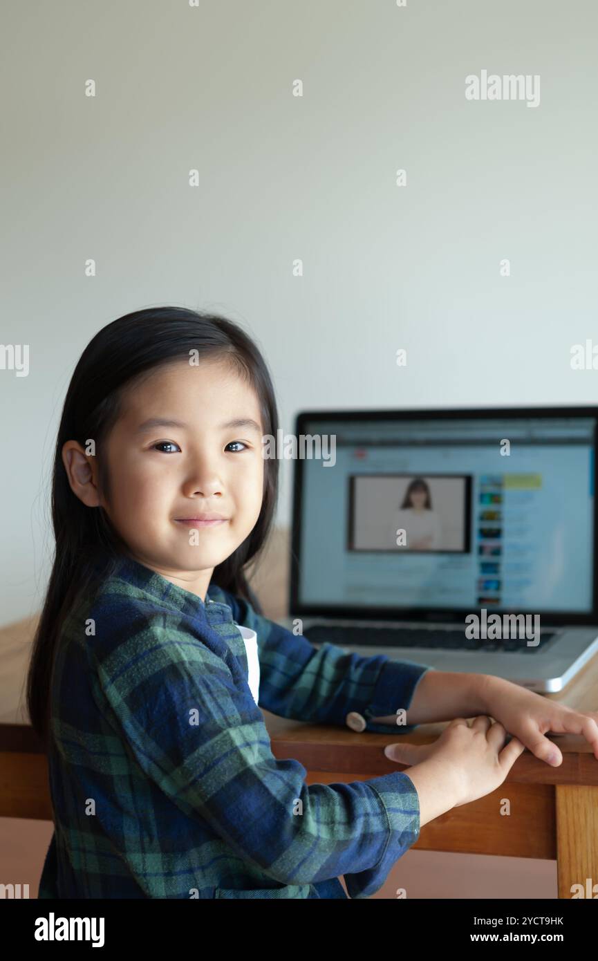 Girl laughing in front of laptop Stock Photo - Alamy