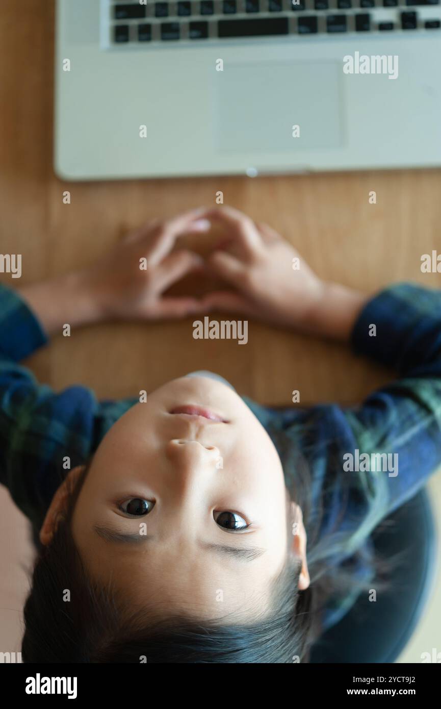 Girl looking up in front of laptop Stock Photo - Alamy