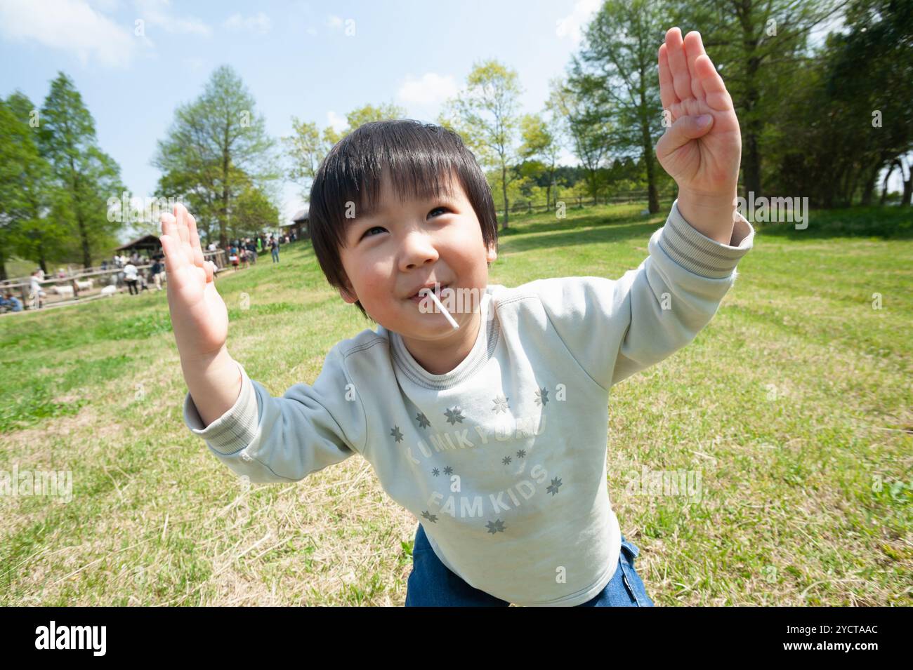 Boy dancing happily while eating candy Stock Photo - Alamy