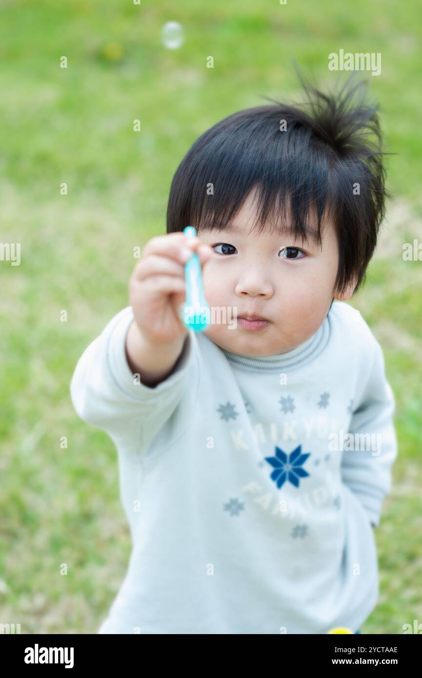 Boy blowing soap bubbles Stock Photo - Alamy