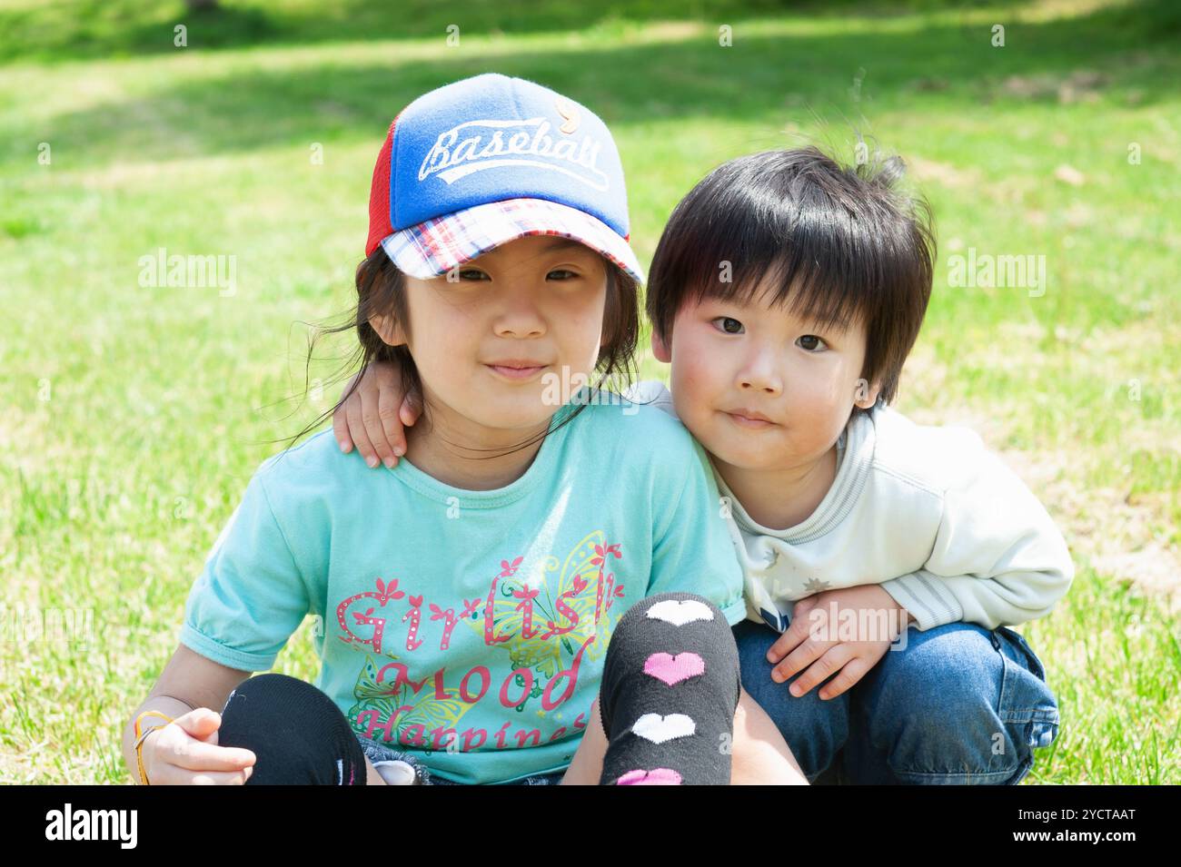 Smiling siblings in a friendly row Stock Photo - Alamy