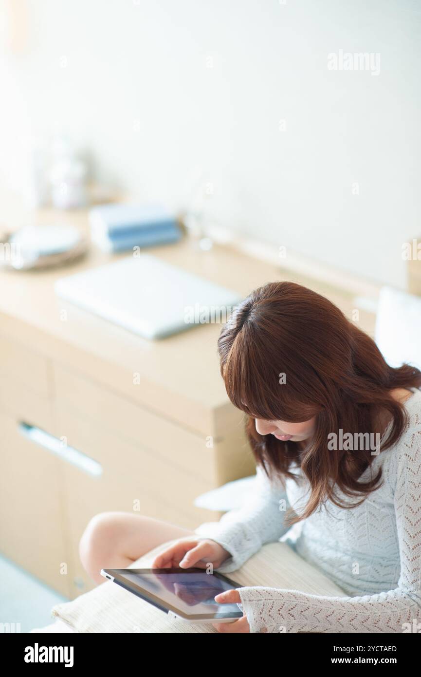 Japanese woman operating tablet Stock Photo - Alamy