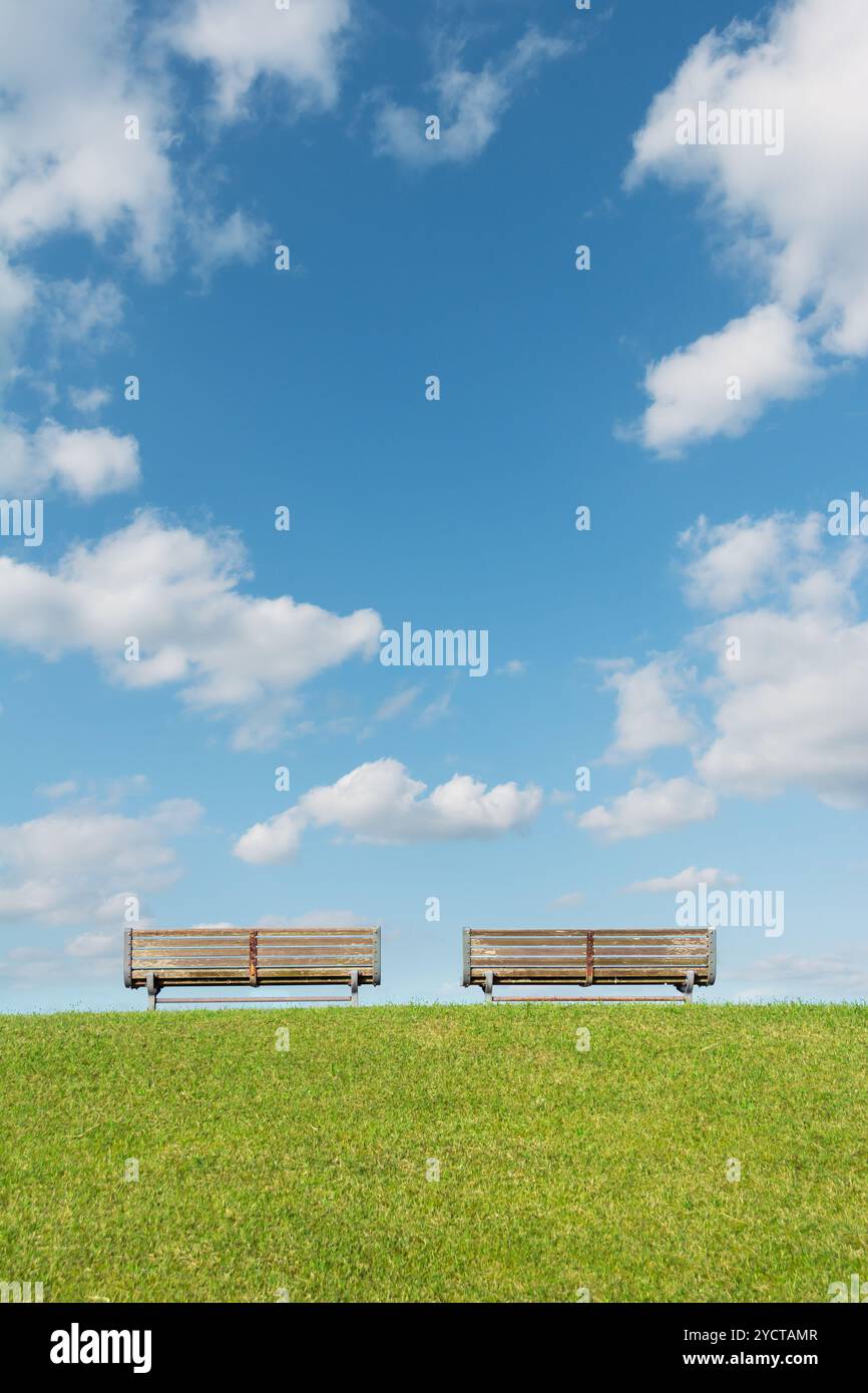 Two benches in the meadow and blue sky Stock Photo - Alamy
