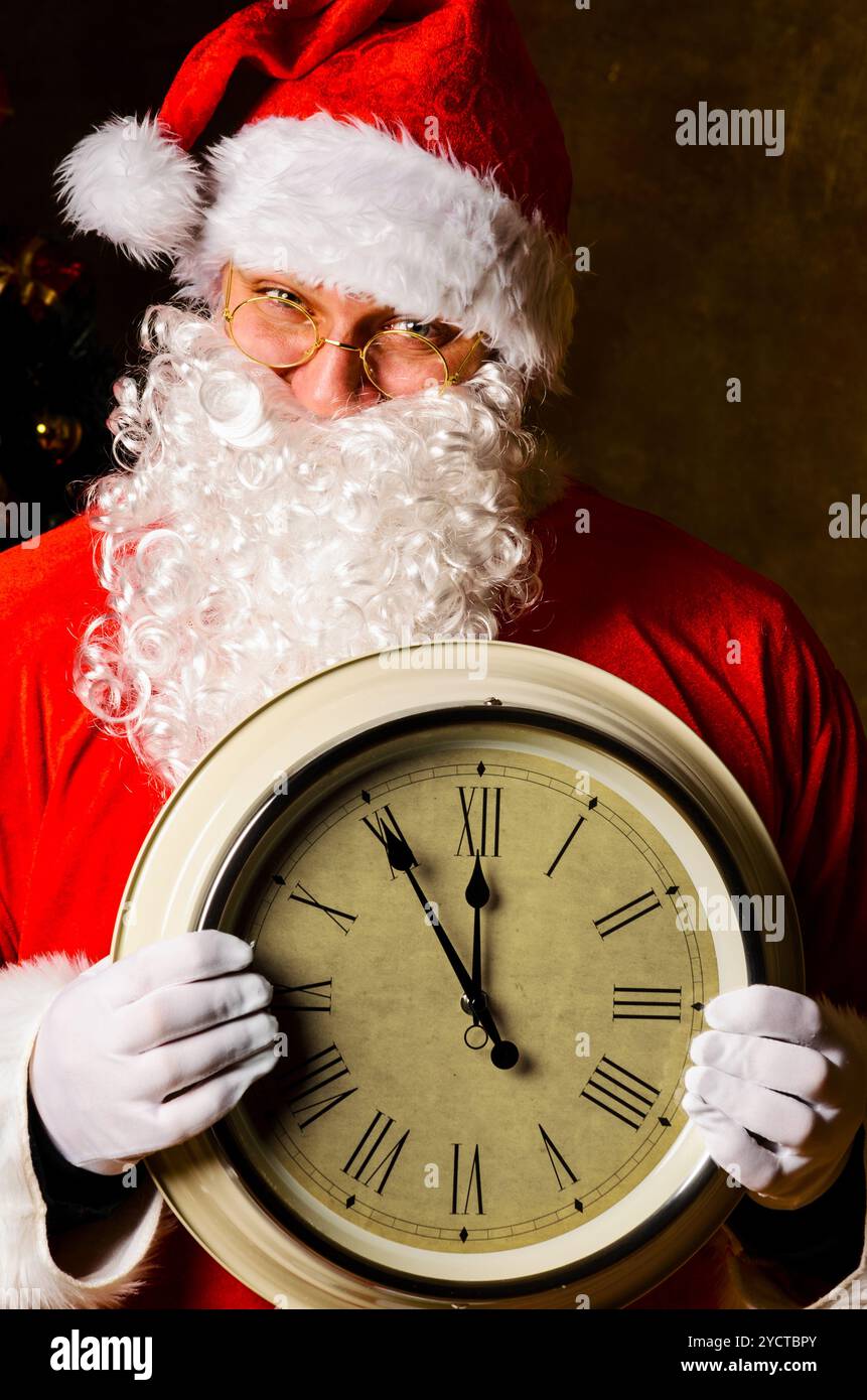 Santa with clock Stock Photo - Alamy