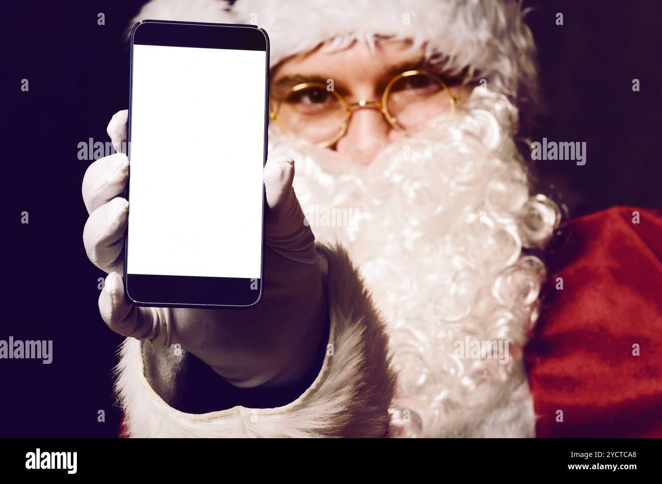 Santa Claus holding smartphone Stock Photo - Alamy