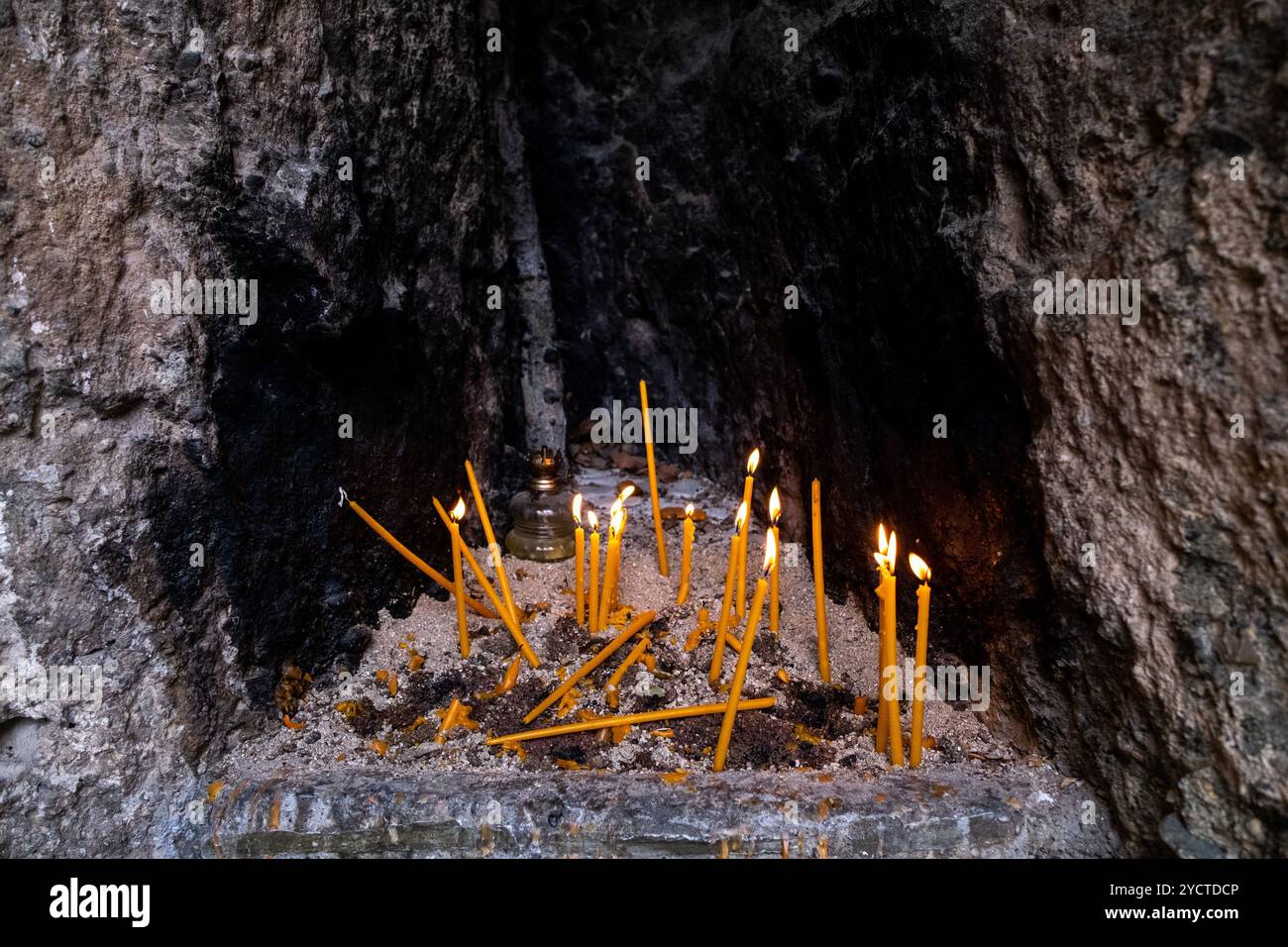 Small Orthodox Christian chapel with candle in a rock mountain of the ...