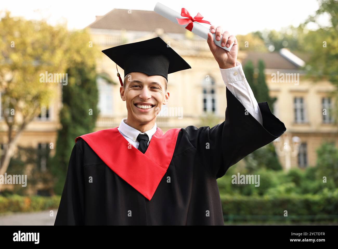 Happy student with diploma after graduation ceremony outdoors Stock ...