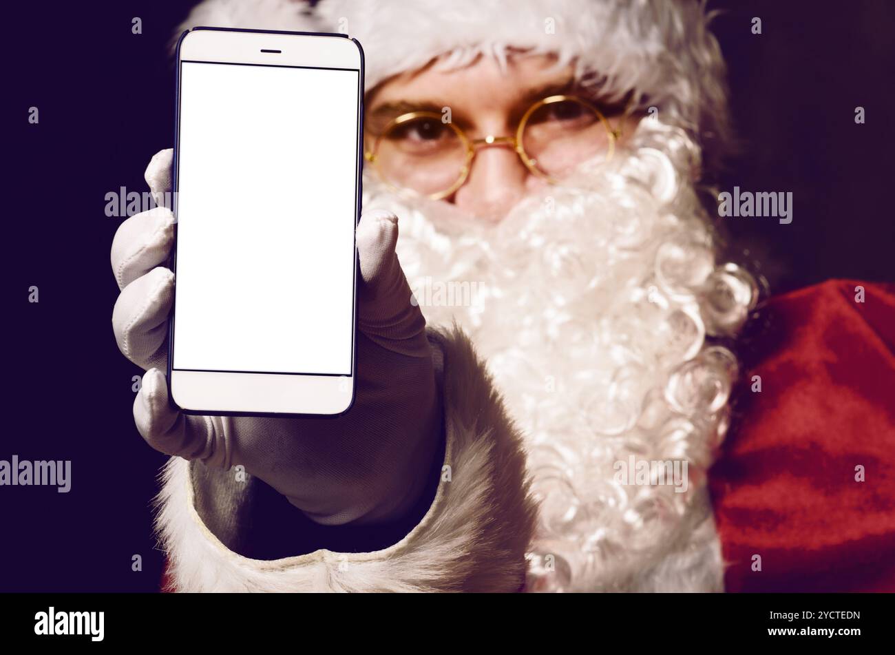 Santa Claus holding smartphone Stock Photo - Alamy
