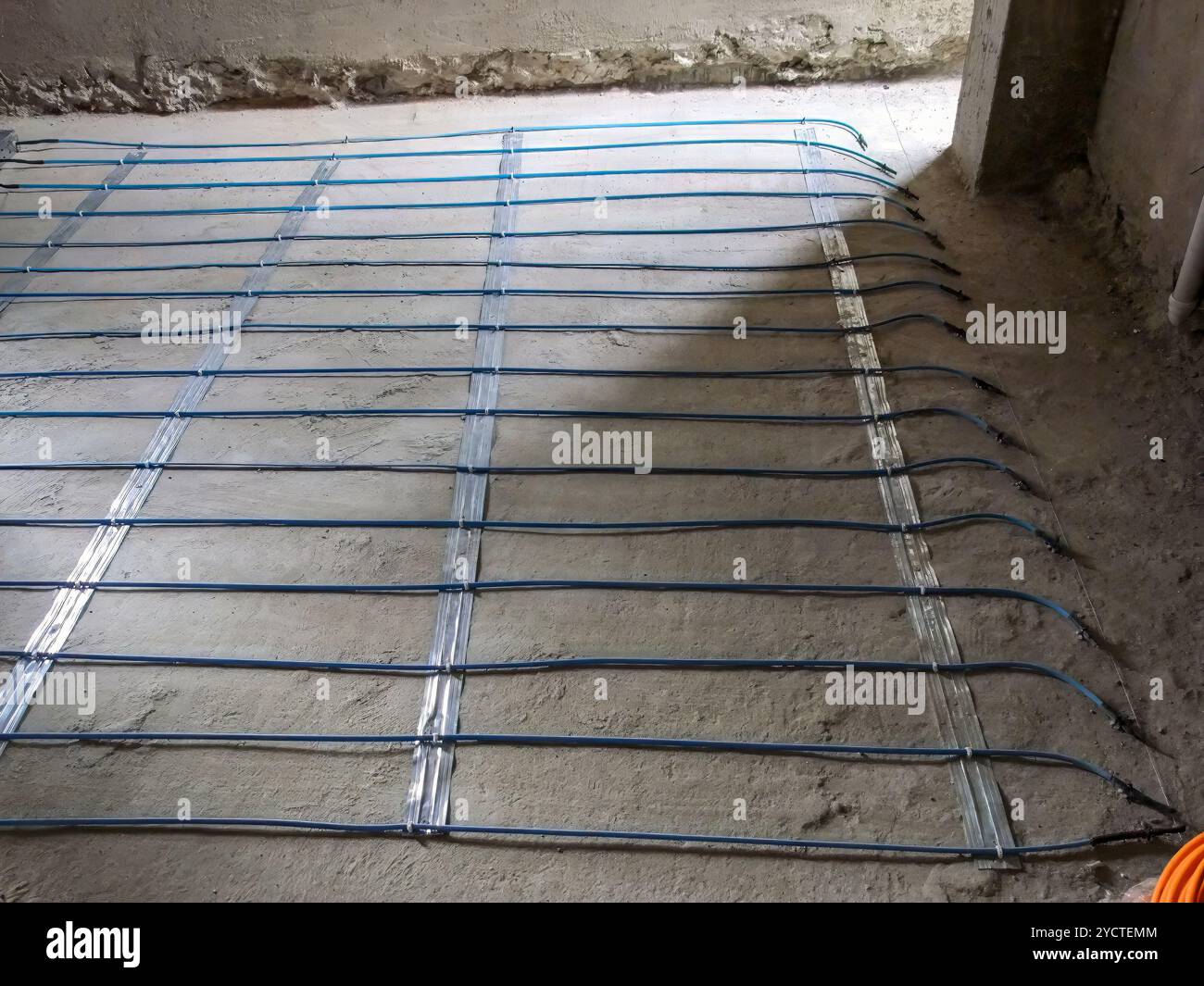 Underfloor heating system with electrical cables laid on a concrete ...
