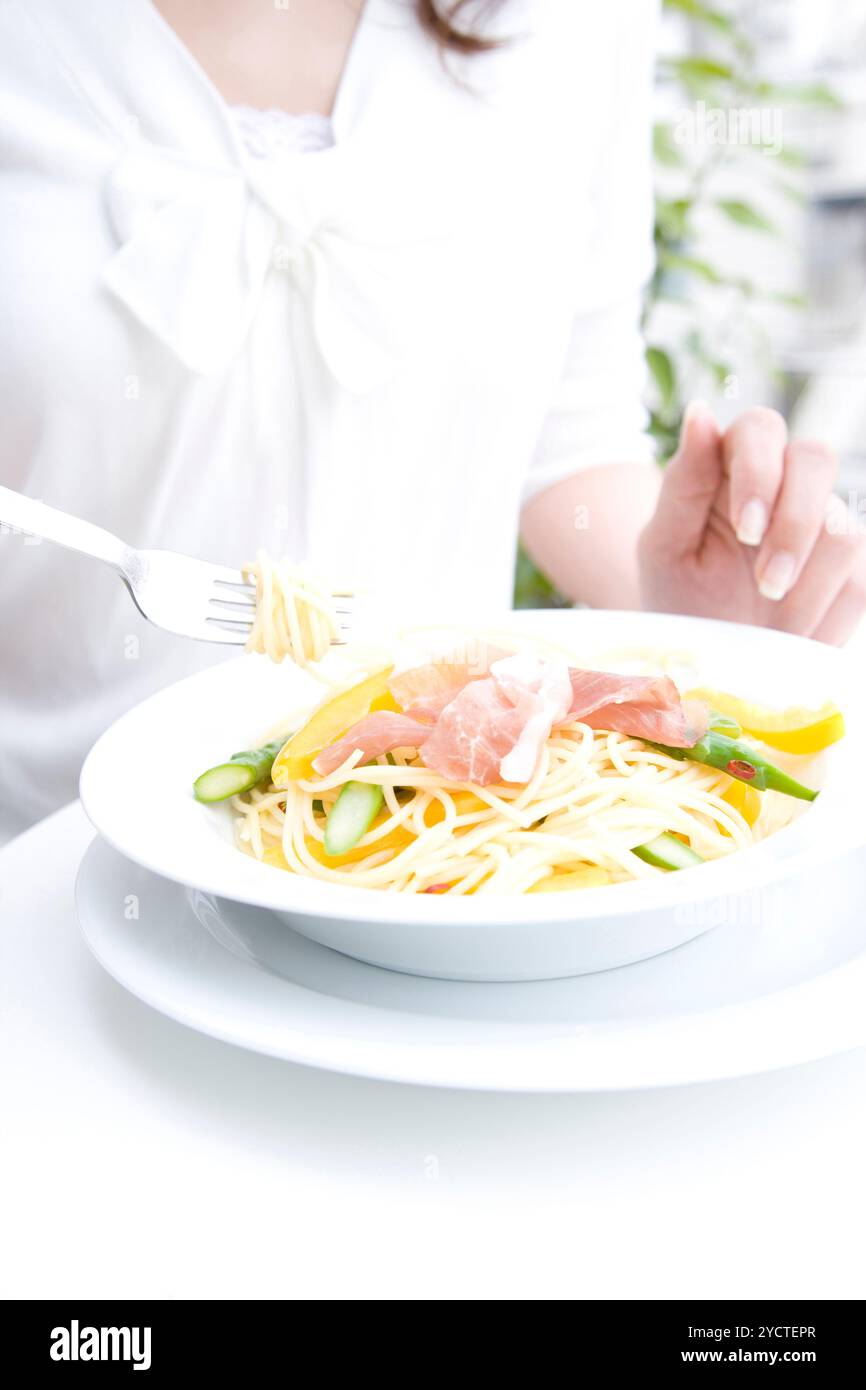 Hand of woman eating pasta Stock Photo - Alamy