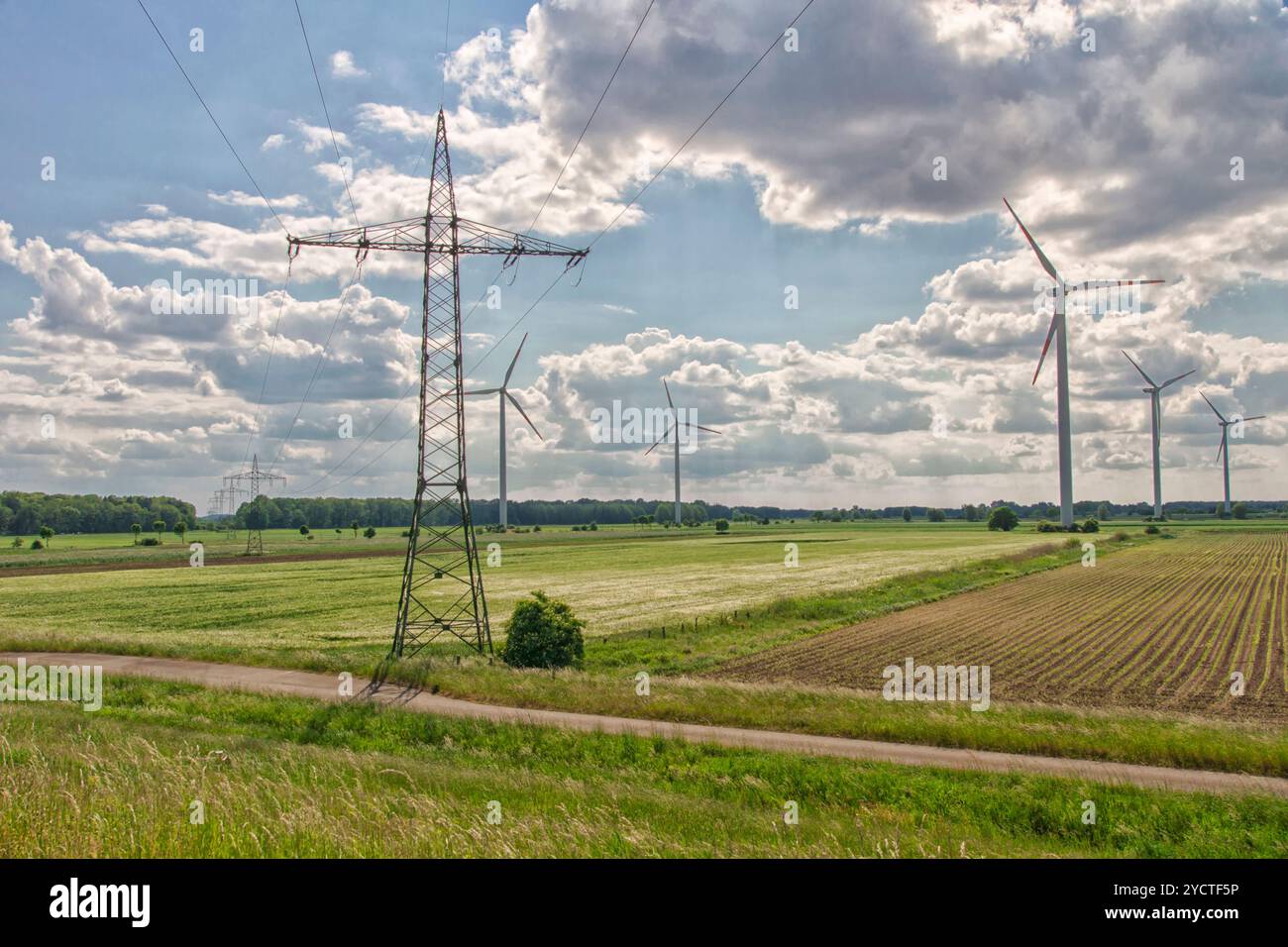 Electricity pylons and wind turbines Stock Photo - Alamy