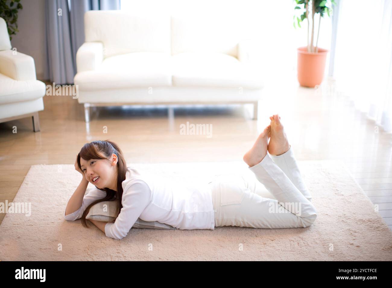 Woman lying on the floor Stock Photo - Alamy