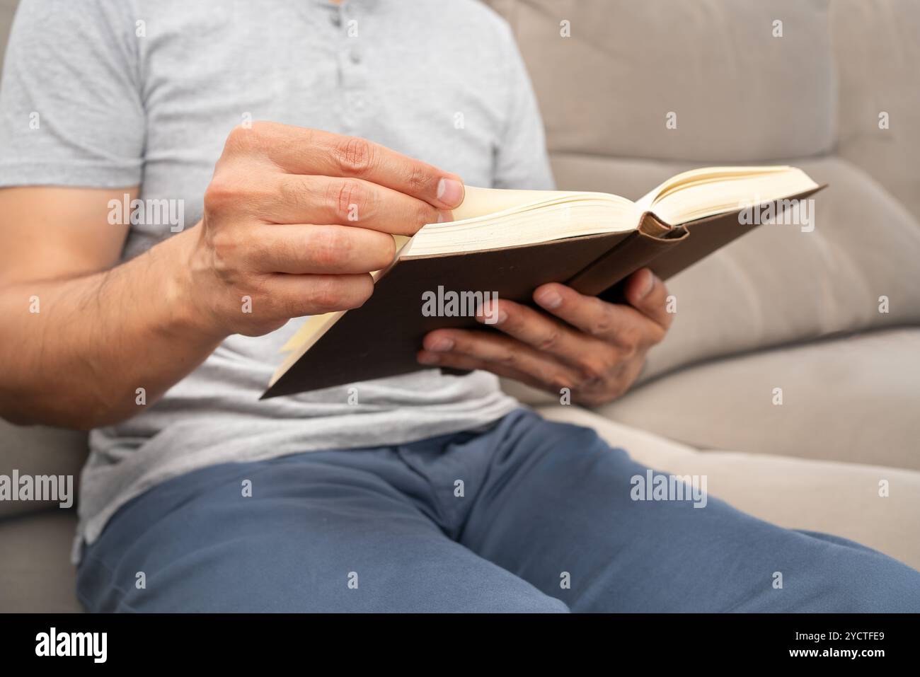 Hand man reading book home hi-res stock photography and images - Alamy