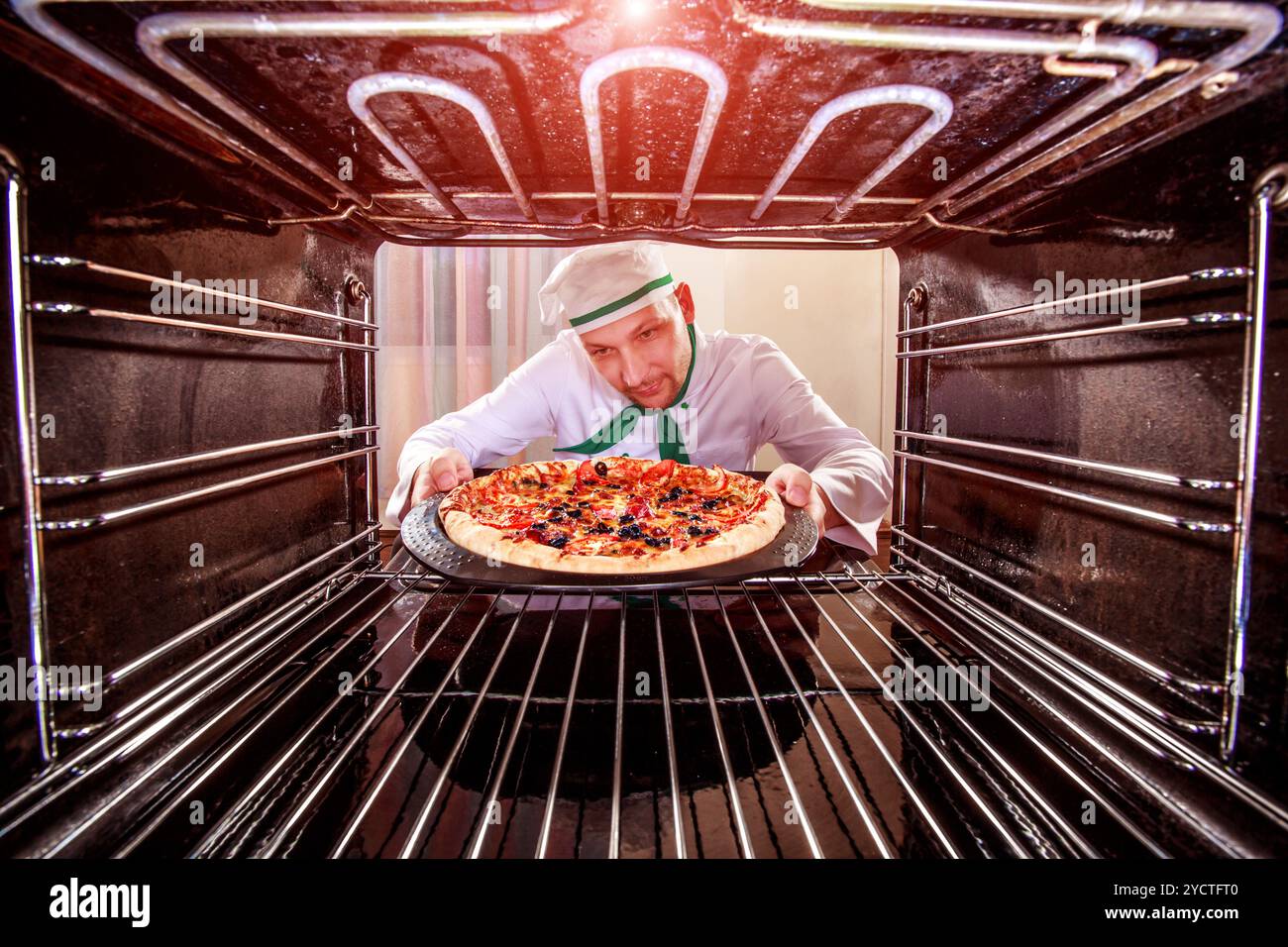 Chef cooking pizza in the oven Stock Photo - Alamy