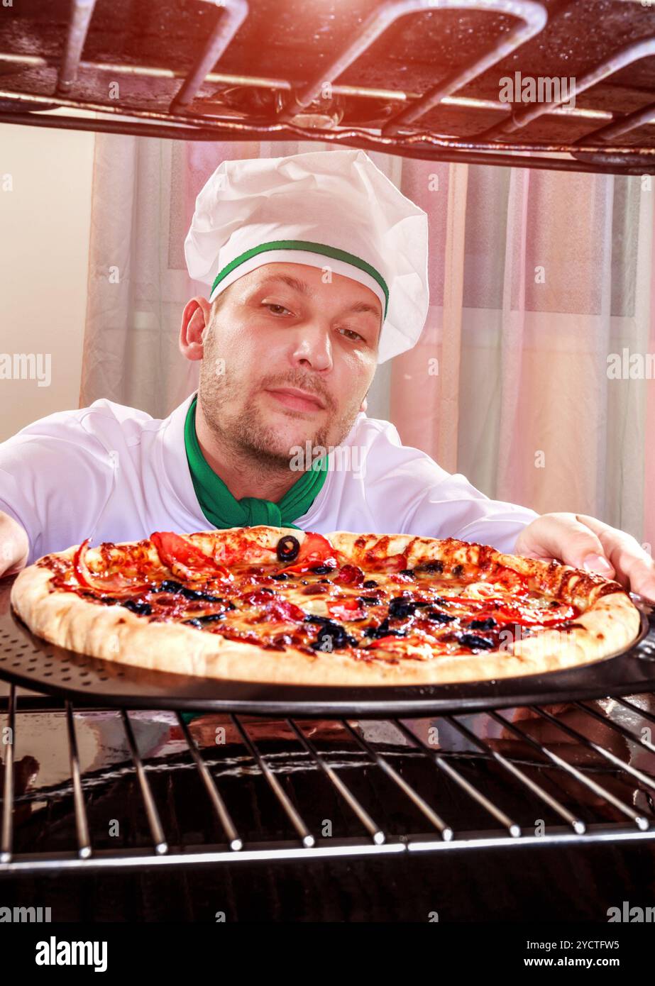 Chef cooking pizza in the oven Stock Photo - Alamy