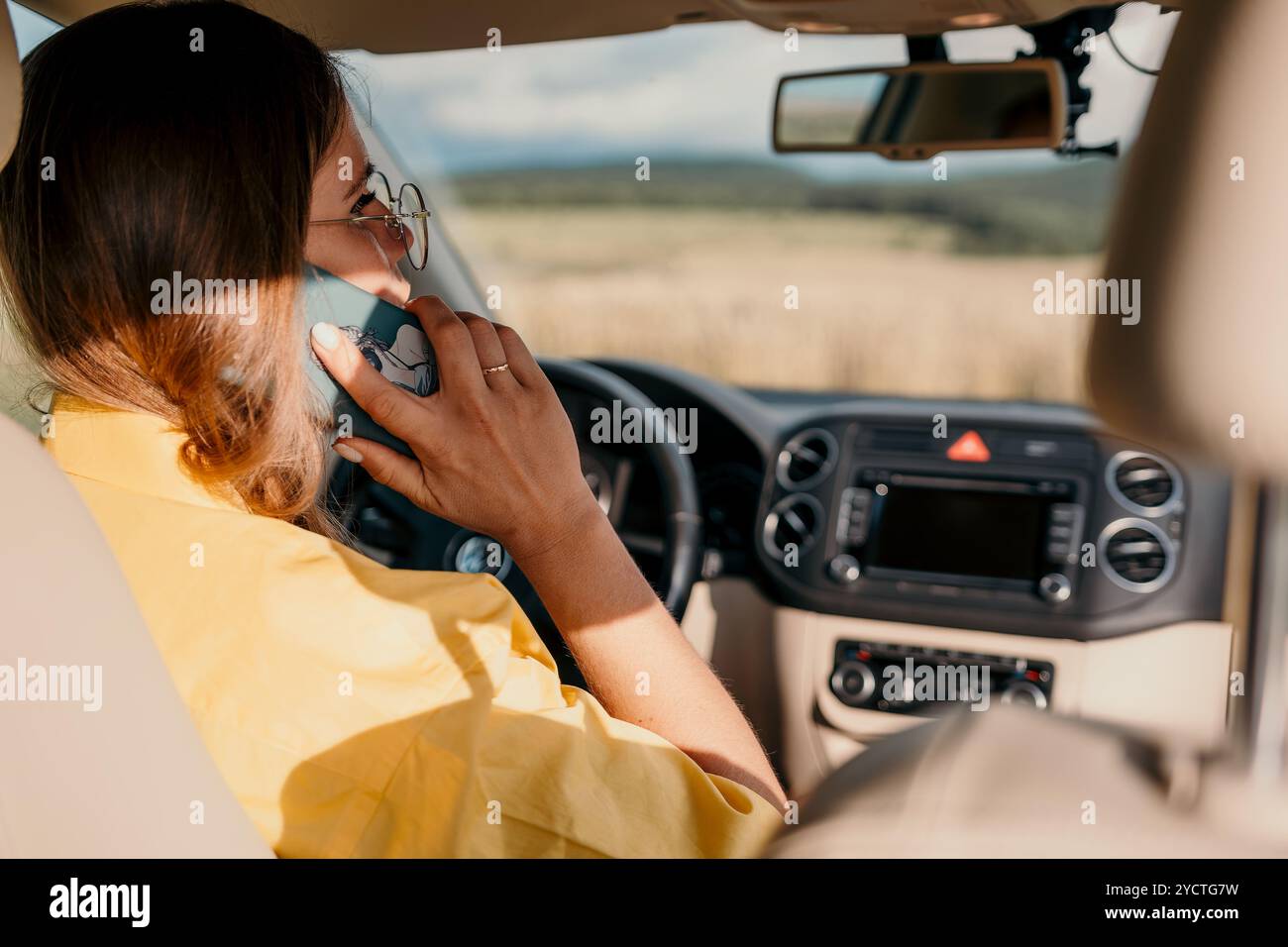 Woman Talking on Phone While Driving Stock Photo - Alamy