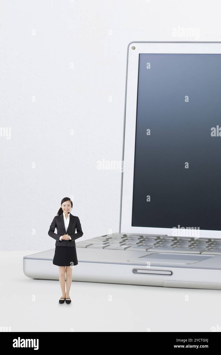 Operator standing in front of laptop Stock Photo - Alamy