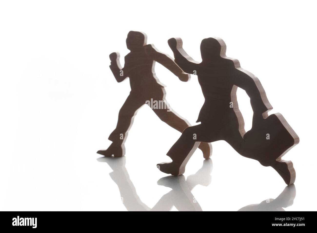 Wood carving of two running businessmen Stock Photo - Alamy