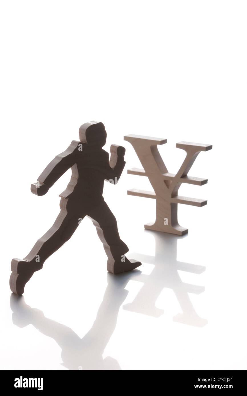 Wooden carved circular symbol and running person Stock Photo - Alamy