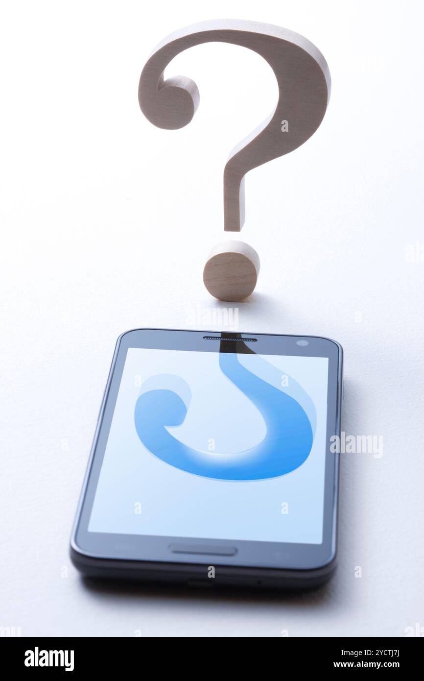 Smartphone and carved wooden question mark symbol Stock Photo - Alamy