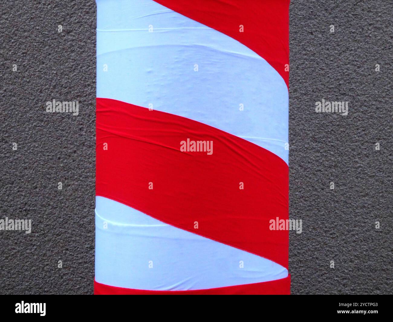 Red and white cloth wrapped around a utility pole Stock Photo - Alamy