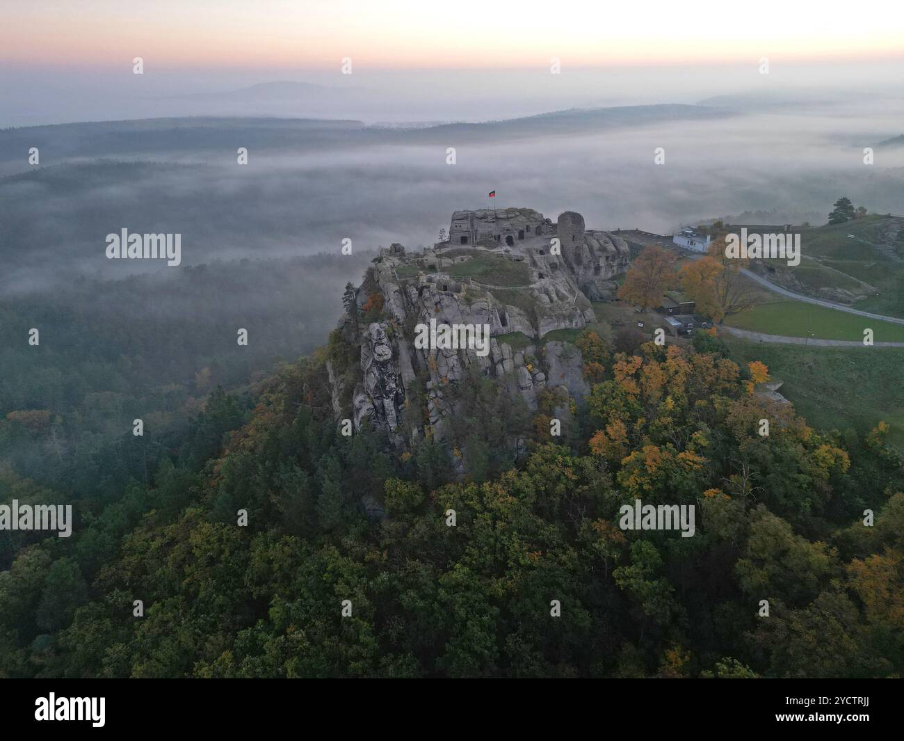 Blankenburg, Germany. 20th Oct, 2024. Fog envelops the ruins of ...