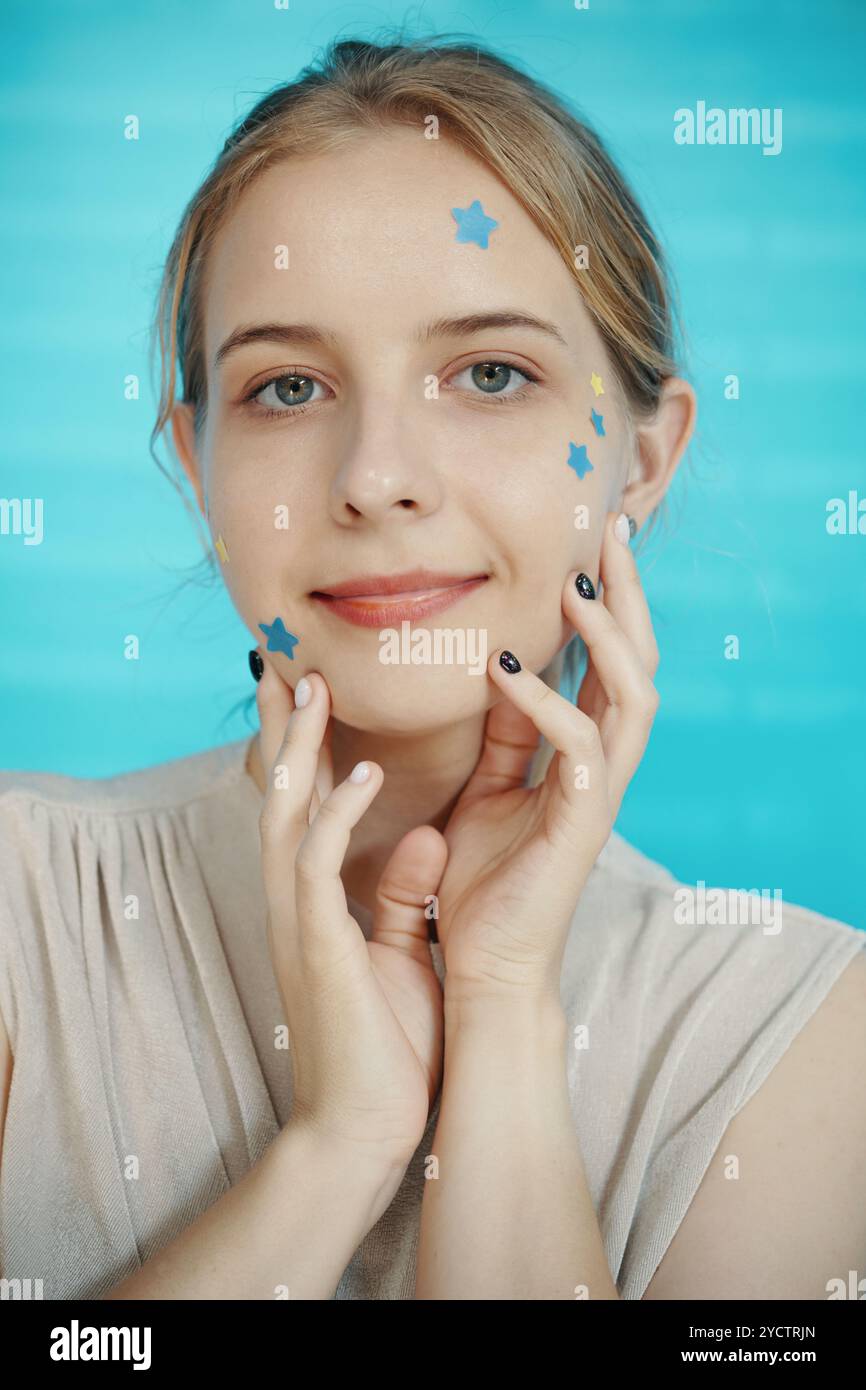 Portrait of Smiling Woman with Star Stickers on Face Stock Photo - Alamy