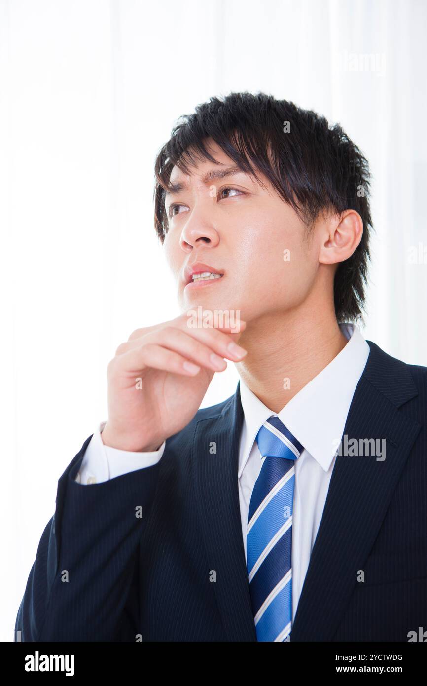 Male businessman thinking Stock Photo - Alamy