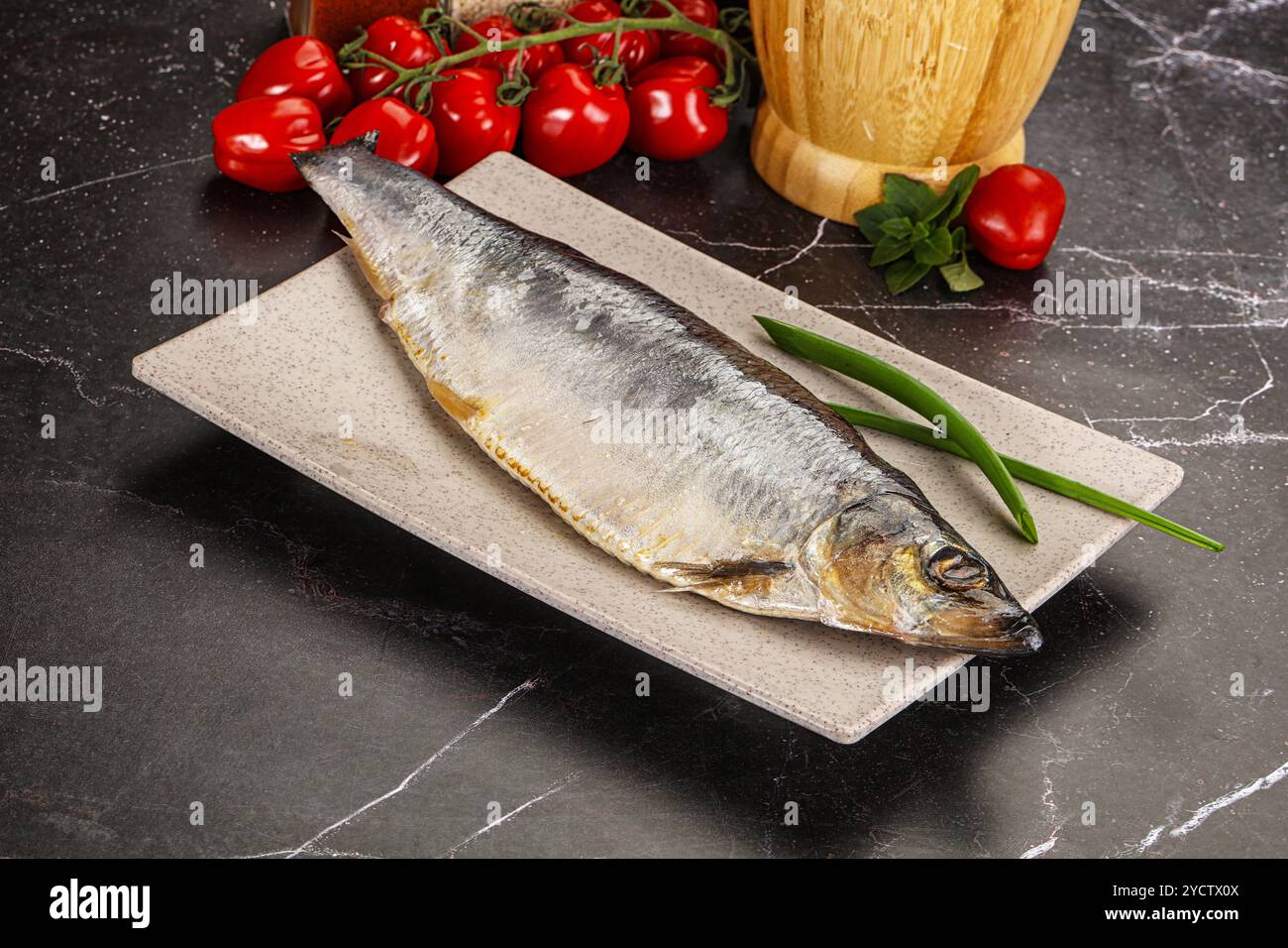 Whole raw salted herring fish in the plate Stock Photo - Alamy