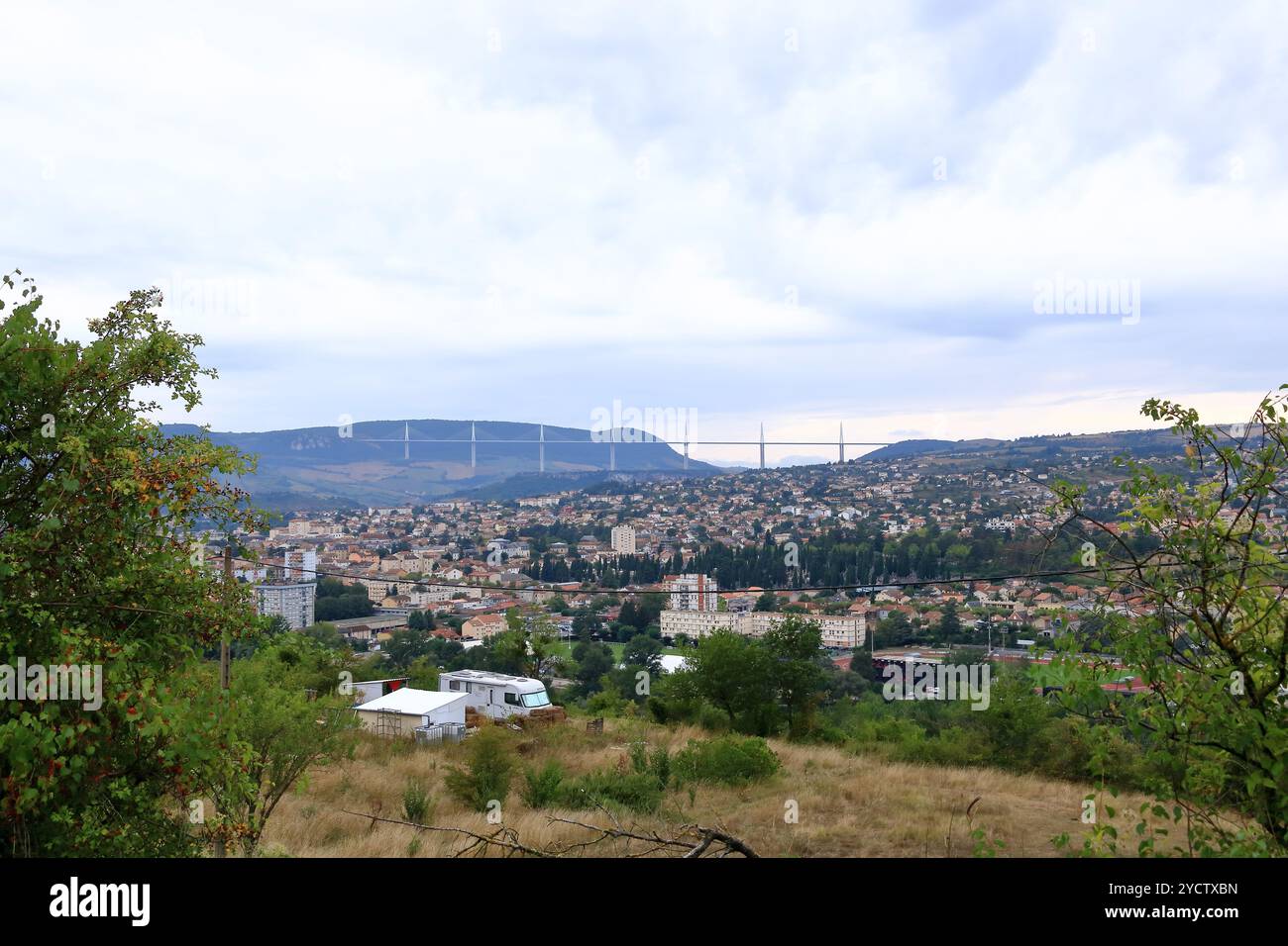 aerial view over the city of Millau with the Viaduct in the background ...