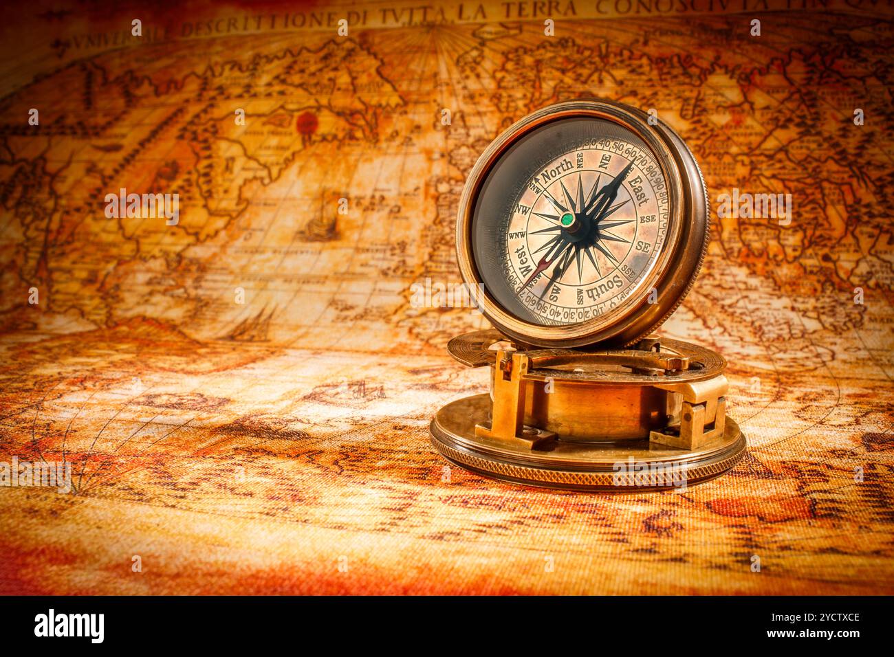Vintage compass lies on an ancient world map Stock Photo - Alamy