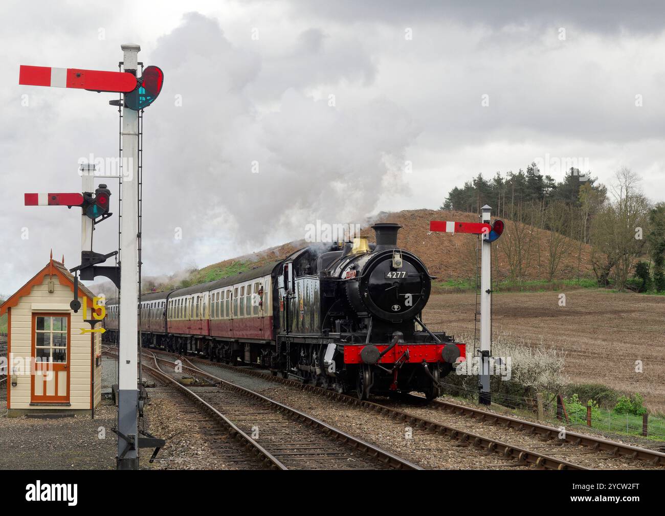 An ex-GWR Class 42XX tank engine runs into Weybourne Station on the ...