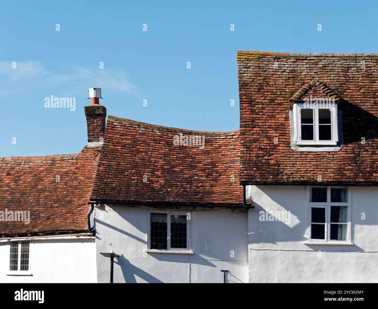 Characterful wavy and uneven flat clay peg-tiled roofs on late medieval ...