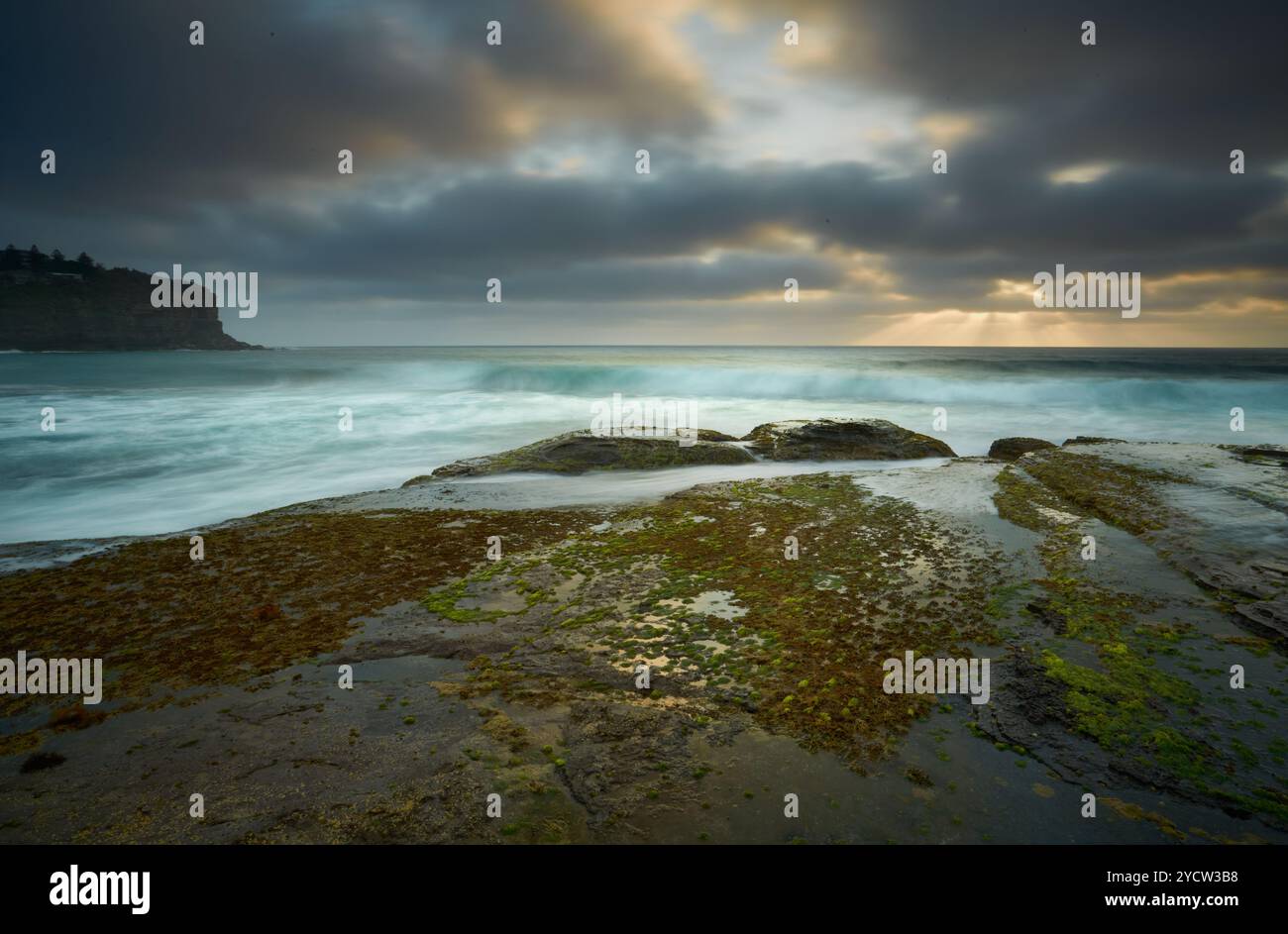 Moody day over Bilgola rockshelf Australia Stock Photo - Alamy