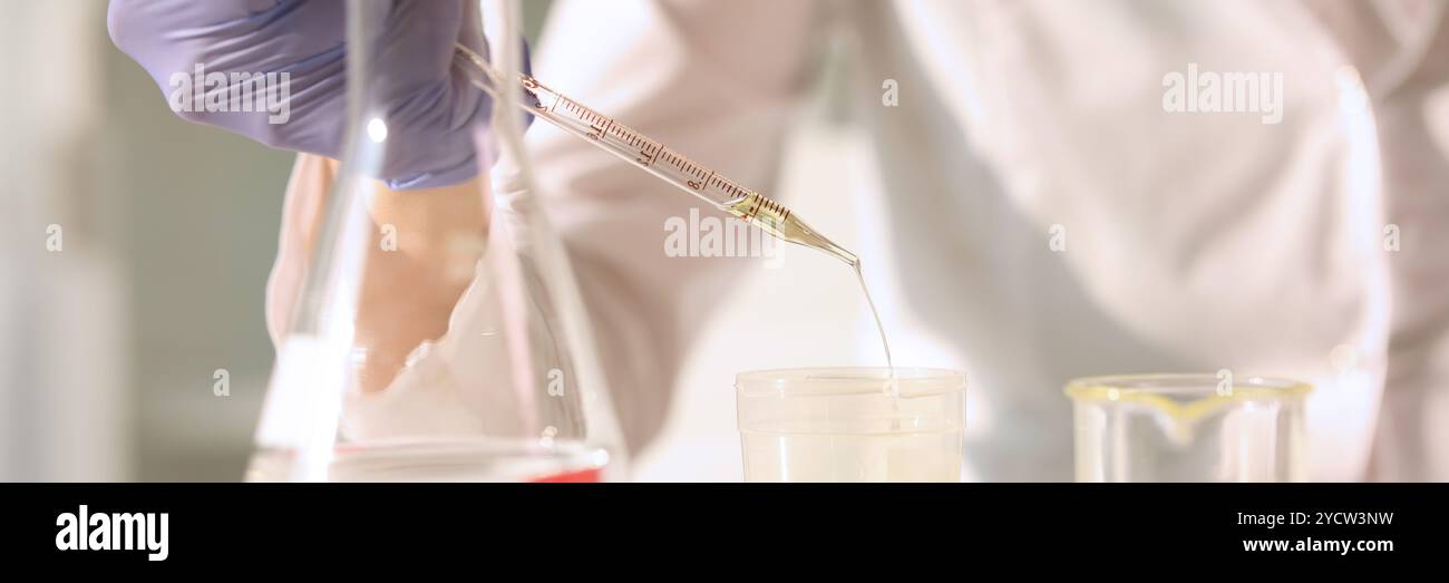 Laboratory worker pours urine into test tube using pipette Stock Photo ...
