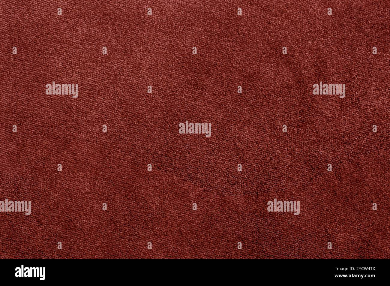 Closeup of a rich red textile, showing a smooth and fine fabric texture ...